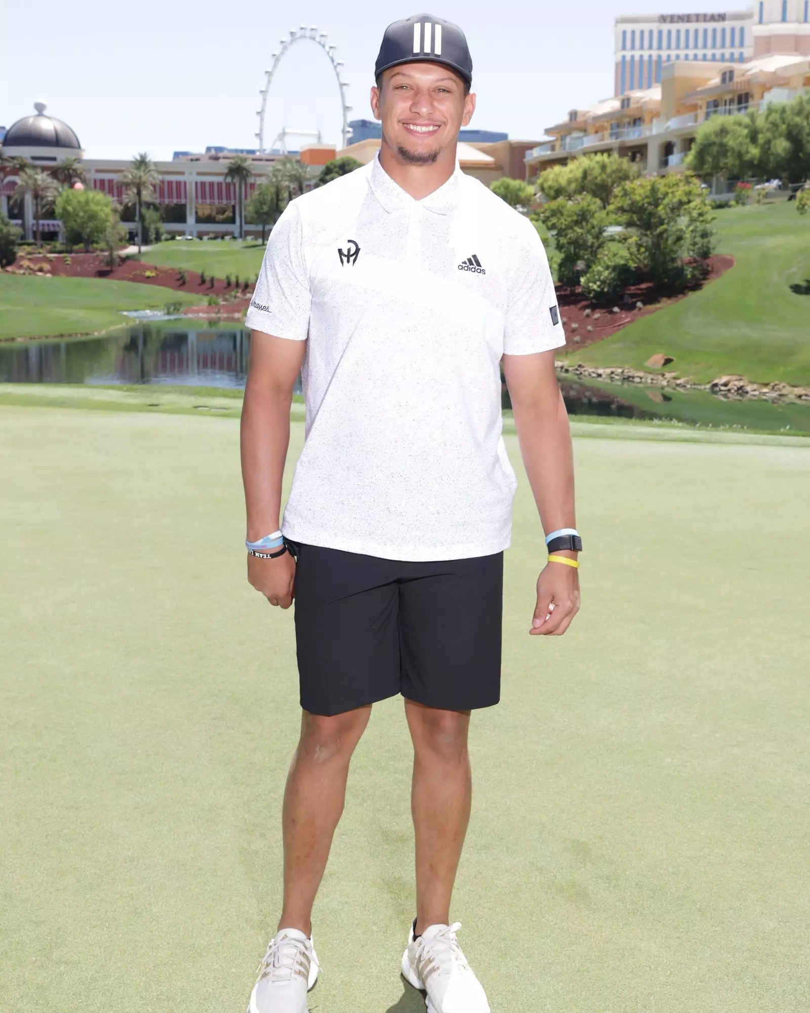 Image mai contain Shorts Clothing Apparel Human Person Footwear Shoe Patrick Mahomes Outdoors Field and Golf
