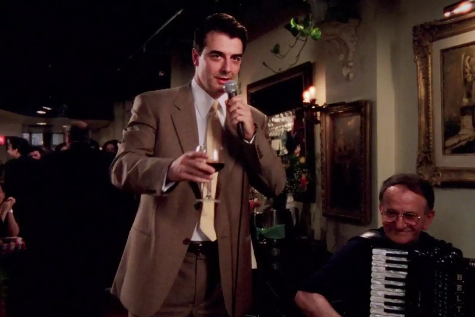 Image mai contain Chris Noth Human Person Musical Instrument Suit Coat Clothing Overcoat Apparel and Accordion