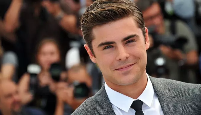 Flýtileið Zac Efron til að fara snemma á fætur í Cannes er að klæða sig upp sem Don Draper