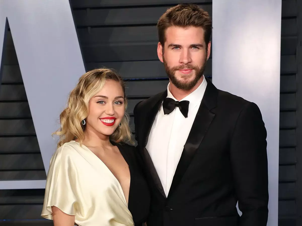 MIley Cyrus at Liam Hemsworth.