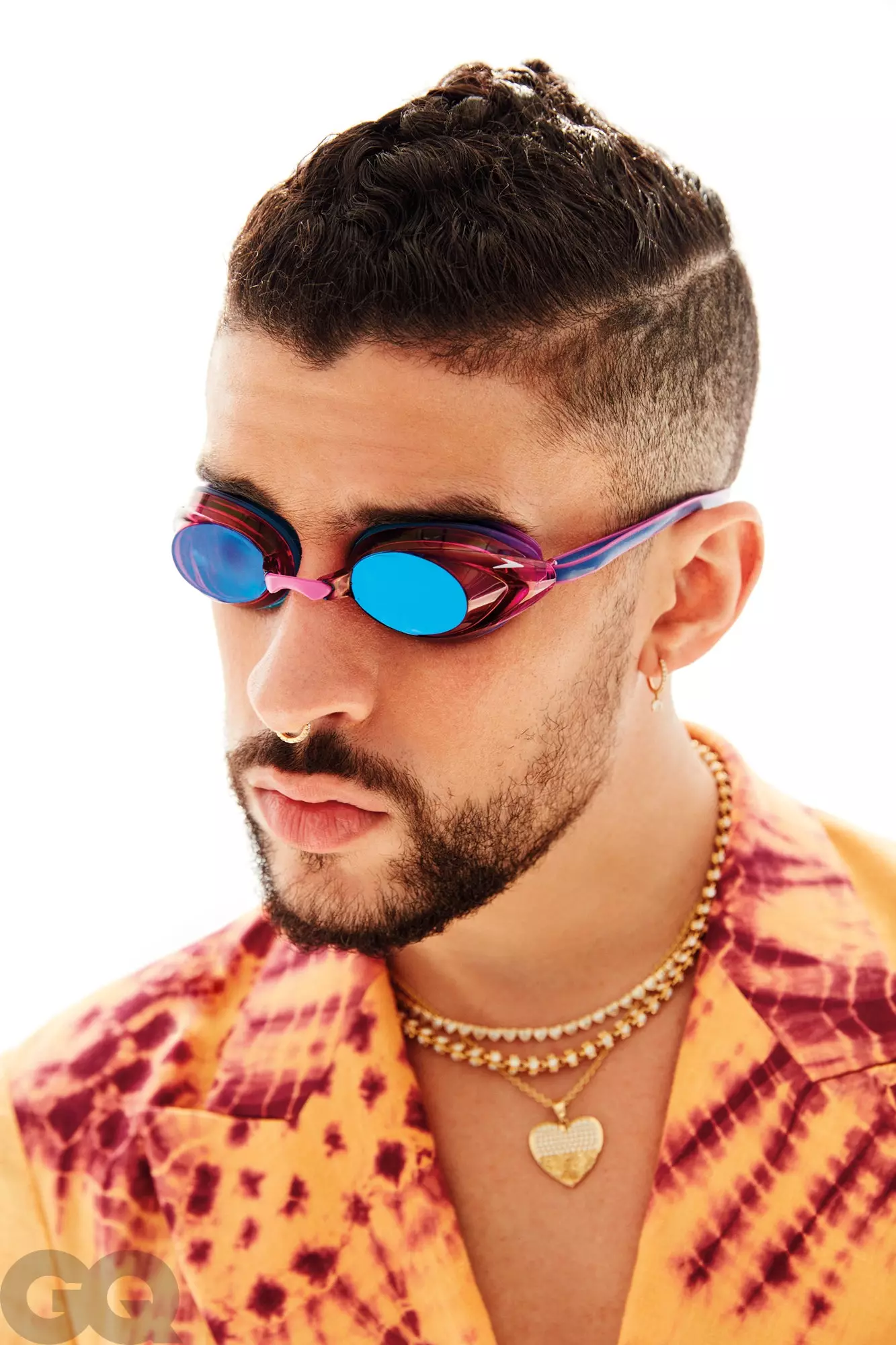 Image may contain Human Person Bad Bunny Sunglasses Accessory Accessory Face Goggles Necklaces and Jewelry